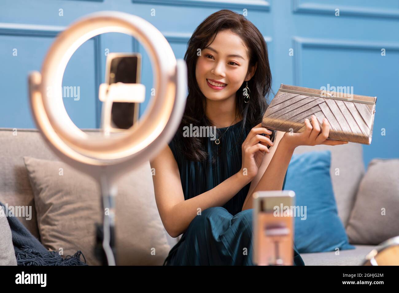 Young woman doing live webcast at home Stock Photo - Alamy