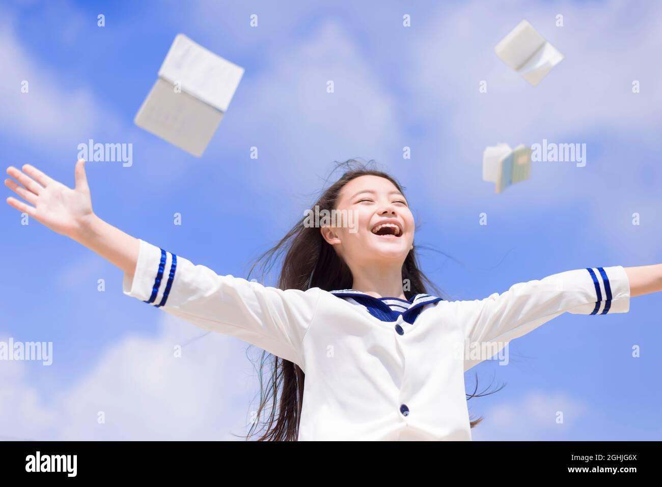 Excited girl student throwing books fly in the air Stock Photo - Alamy