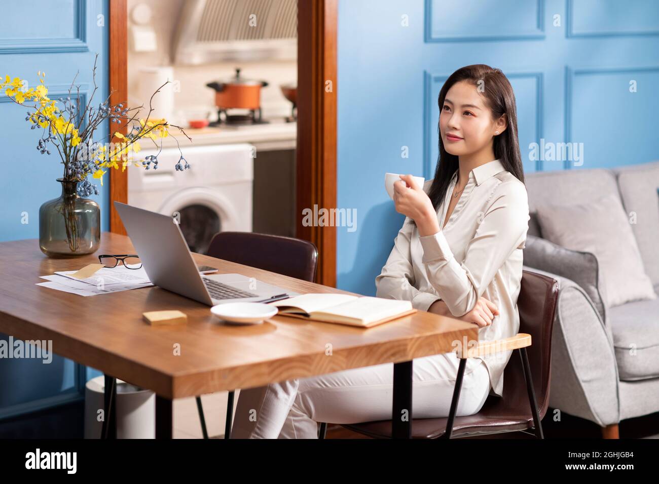 Young woman drinking coffee at home Stock Photo - Alamy