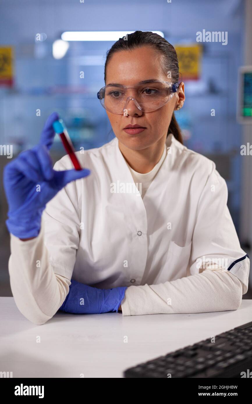 Chemical industry woman working with blood sample flask for treatment ...