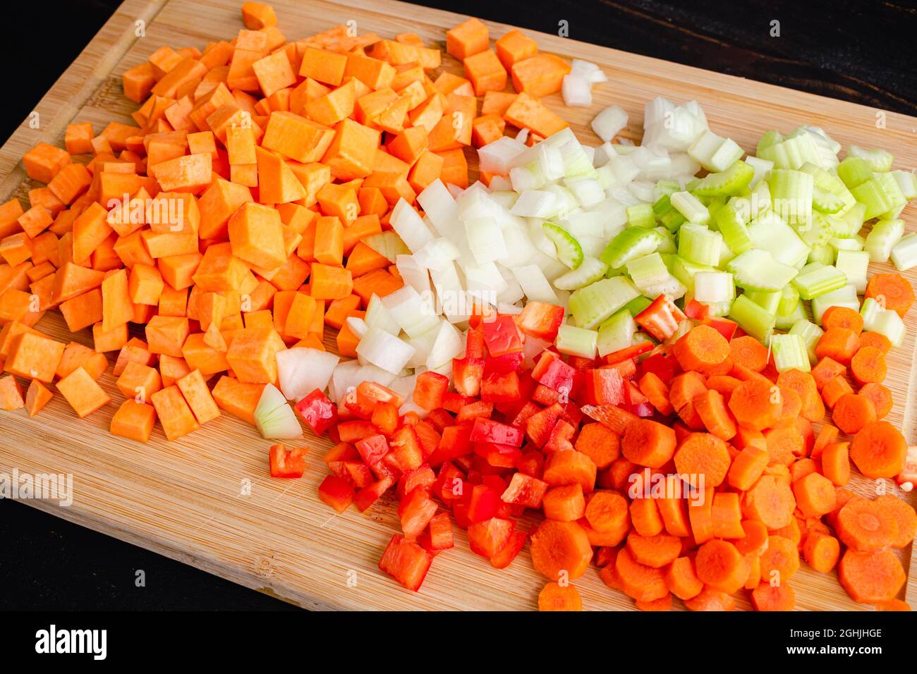 Chopped Vegetables on a Bamboo Cutting Board: Peeled and diced sweet ...