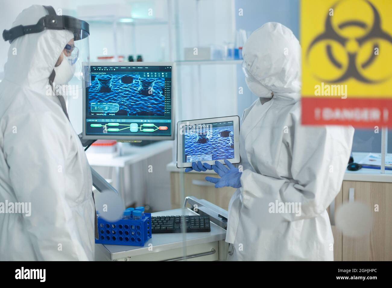 Medical teamwork of scientists wearing protective suit analyzing virus ...