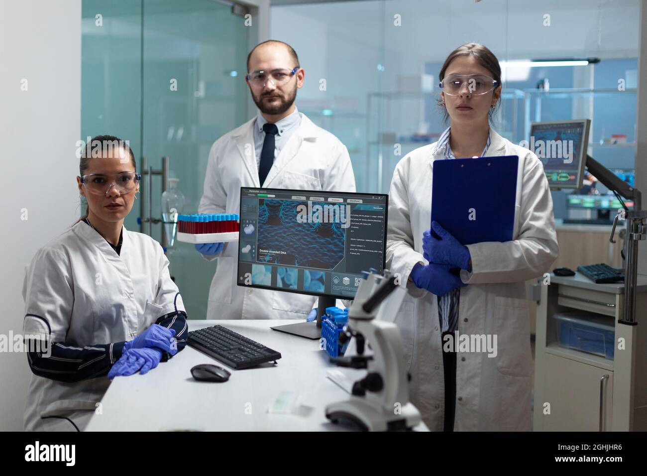 Portrait of medical scientist team working in microbiology hospital laboratory monitoring ...