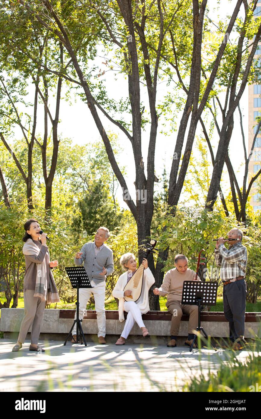 Cheerful senior adult playing traditional musical instruments Stock ...