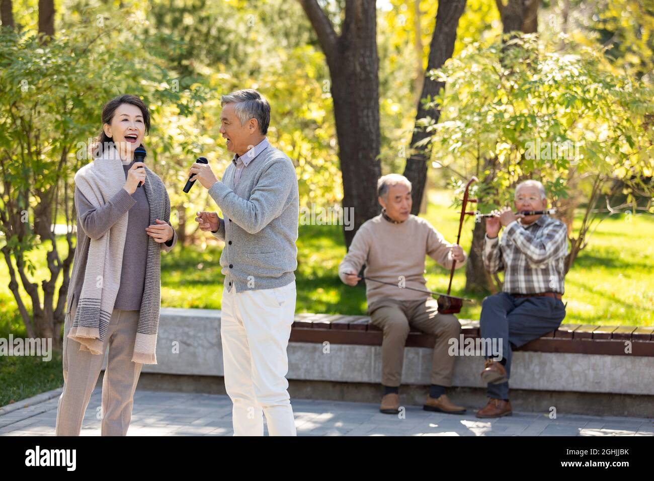 Cheerful senior adult singing with microphones Stock Photo - Alamy