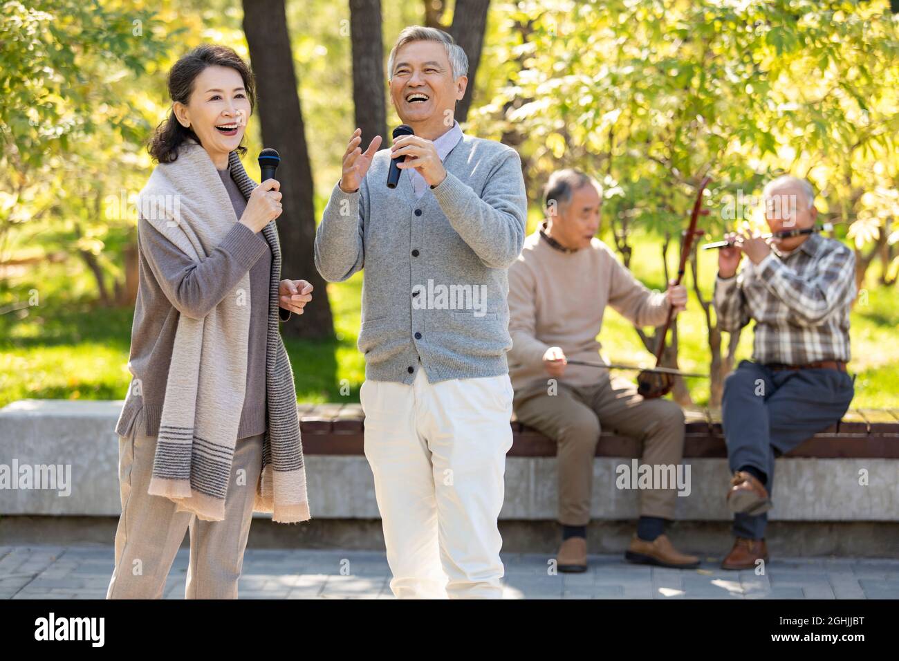 Cheerful senior adult singing with microphones Stock Photo - Alamy