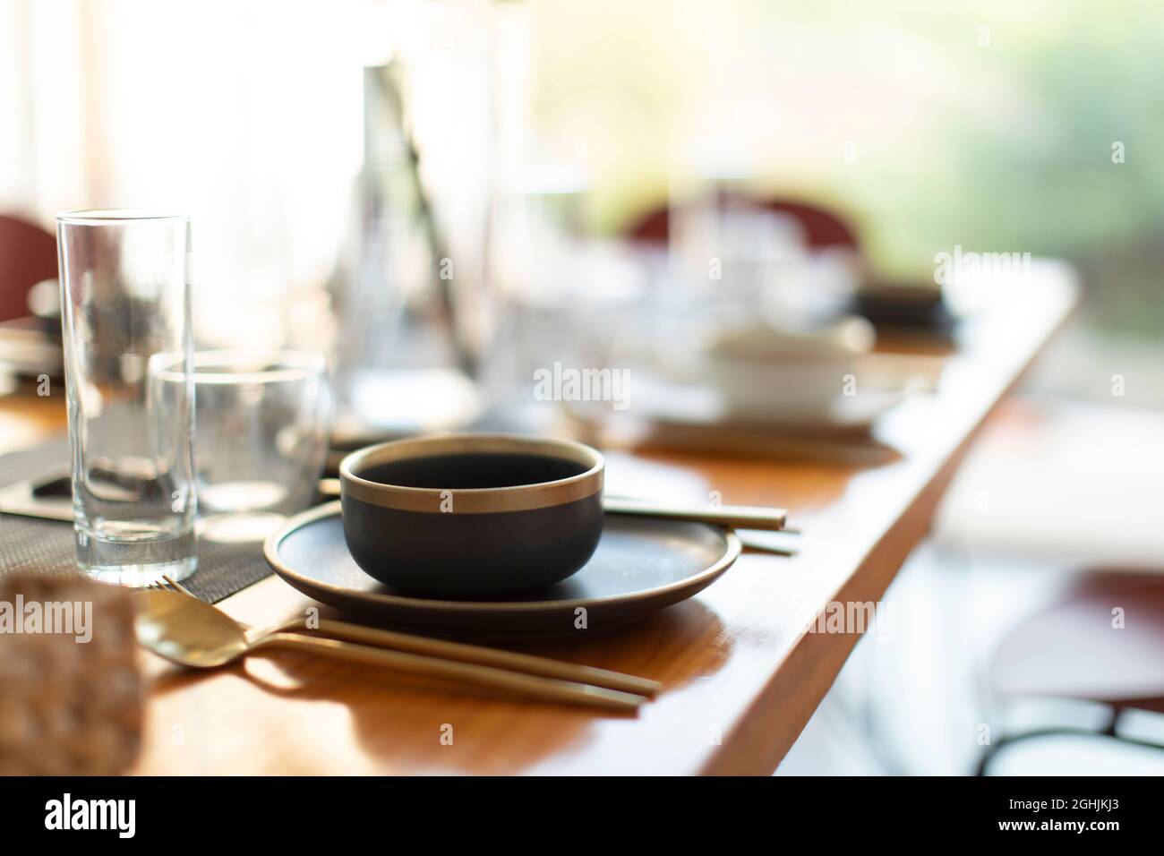 Place settings on dining table Stock Photo - Alamy