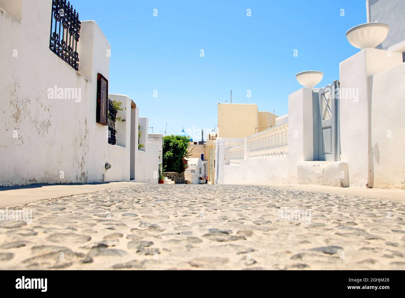 A cobblestone street in the traditional village of Megalochori in ...