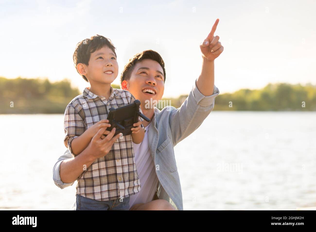 Happy father and son playing with remote control toy Stock Photo - Alamy