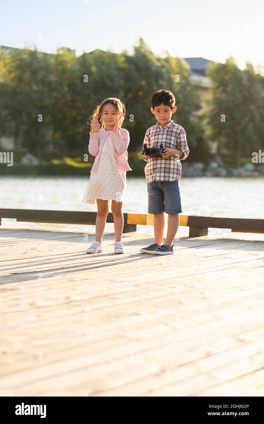 Happy children playing with remote control toy Stock Photo - Alamy