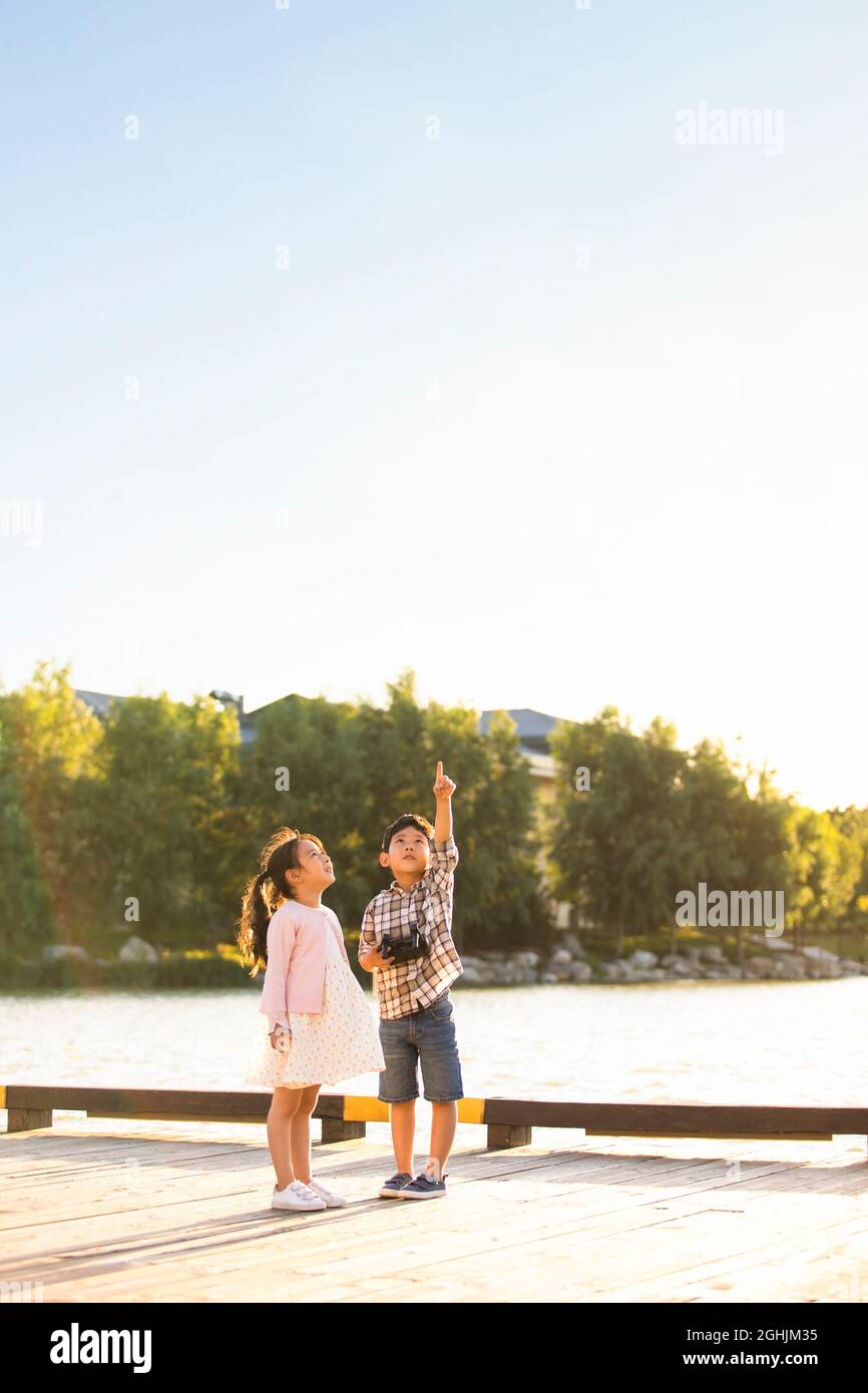 Happy children playing with remote control toy Stock Photo - Alamy