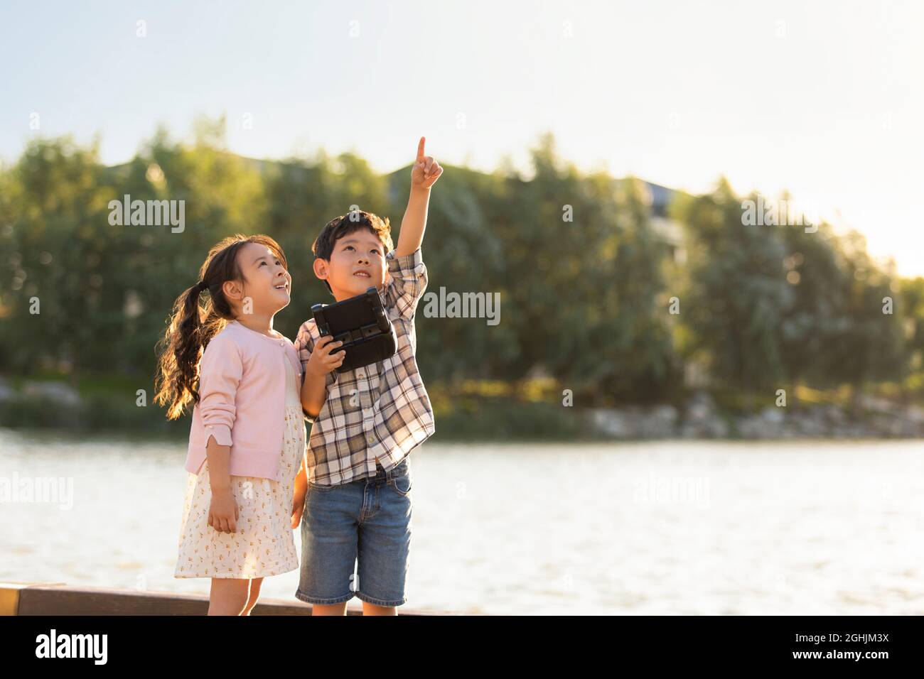 Happy children playing with remote control toy Stock Photo - Alamy