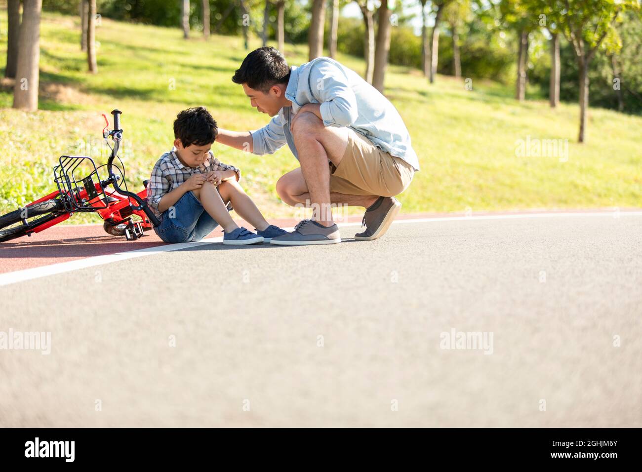 Little boy falling off his bike Stock Photo - Alamy