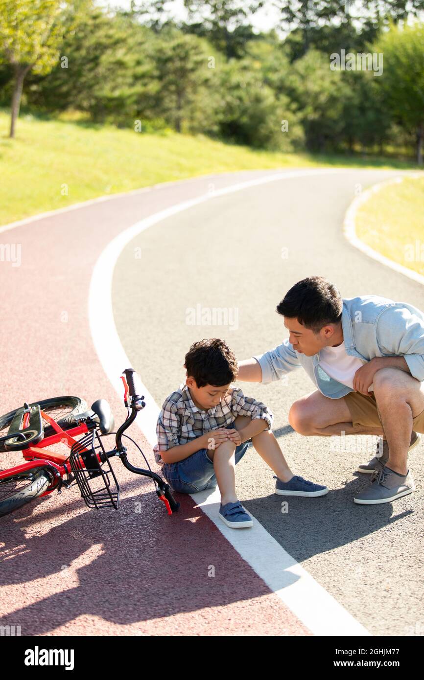 Little boy falling off his bike Stock Photo - Alamy