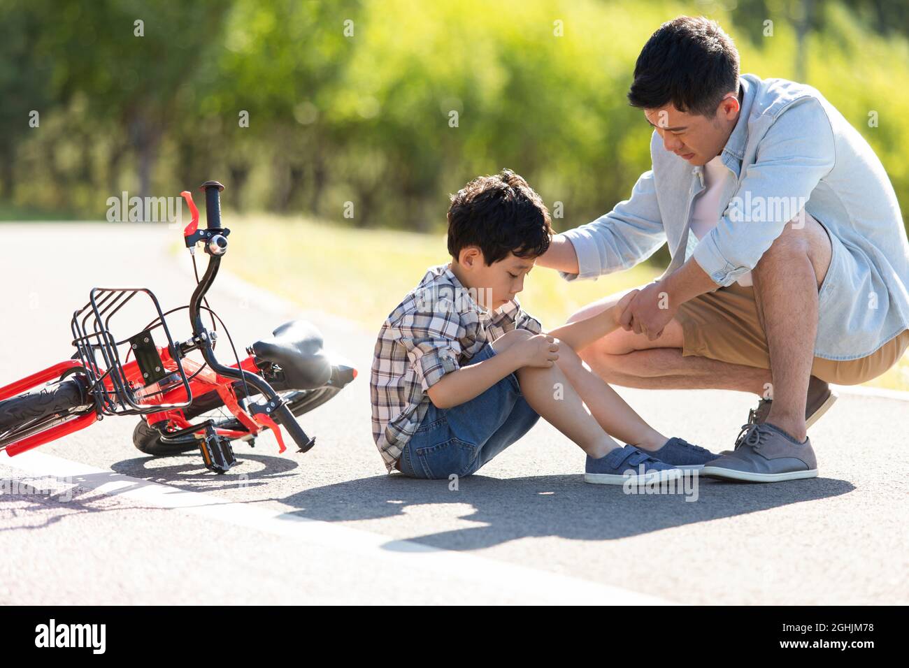 Little boy falling off his bike Stock Photo - Alamy