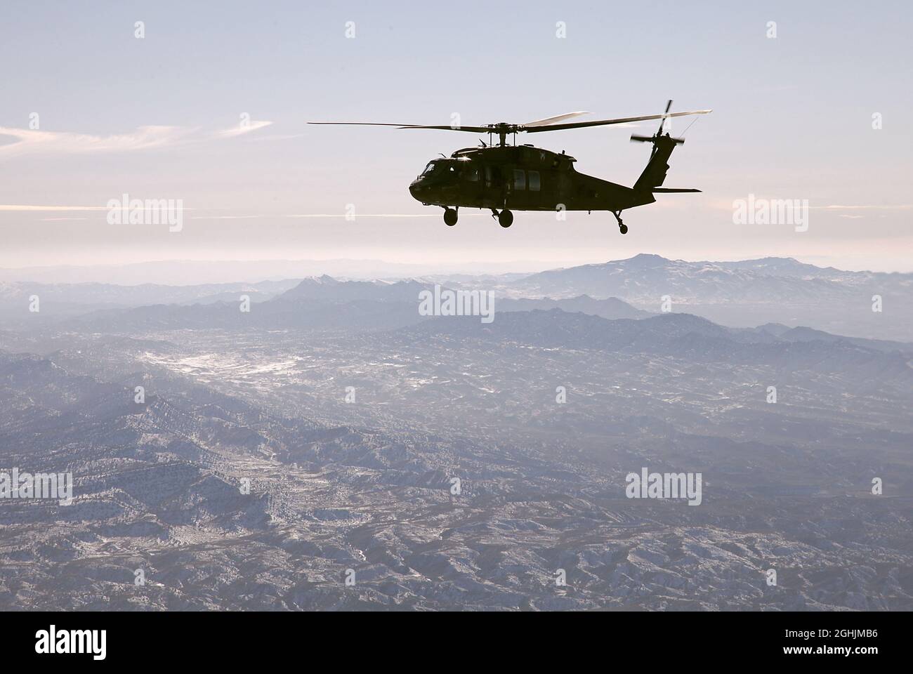 A UH-60 Blackhawk helicopter flies above the Afghan countryside. This ...