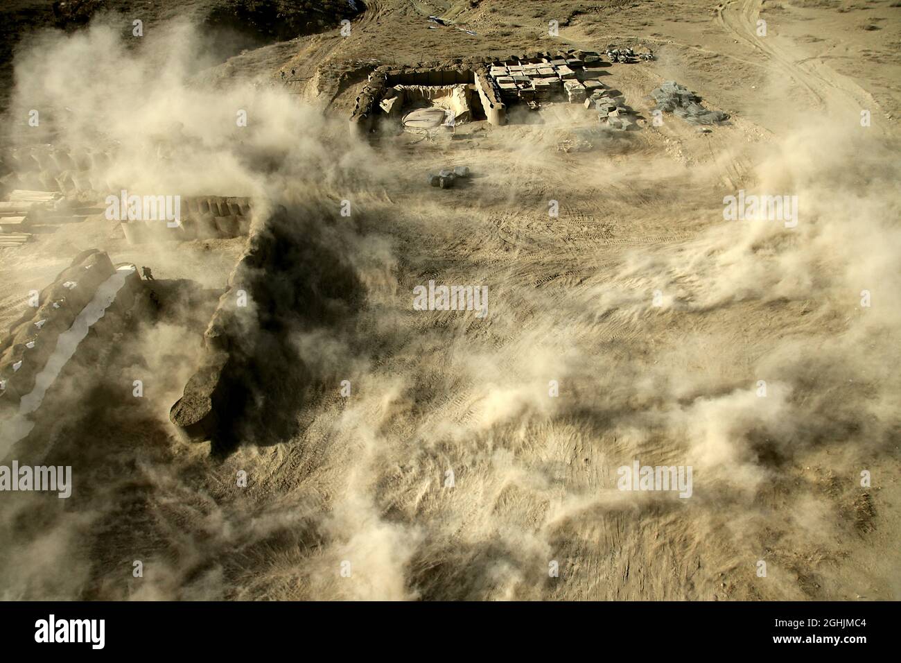 Dust swirls as a CH-47 Chinook prepares to land on Combat Outpost Zerok ...