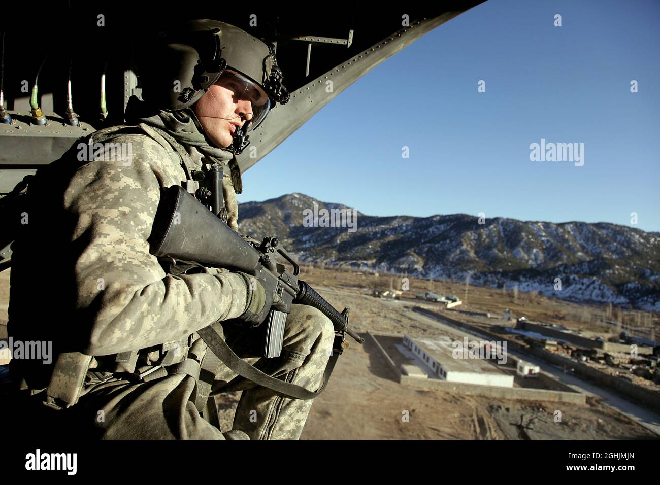 A CH-47 Chinook crew chief pulls security from the ramp of the ...