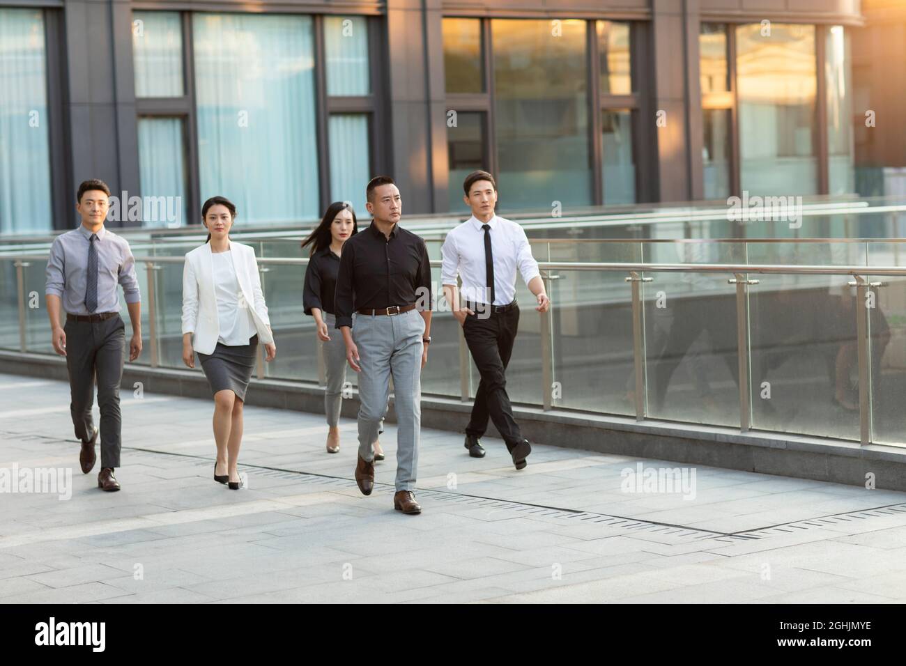 Confident business people walking outdoors Stock Photo - Alamy