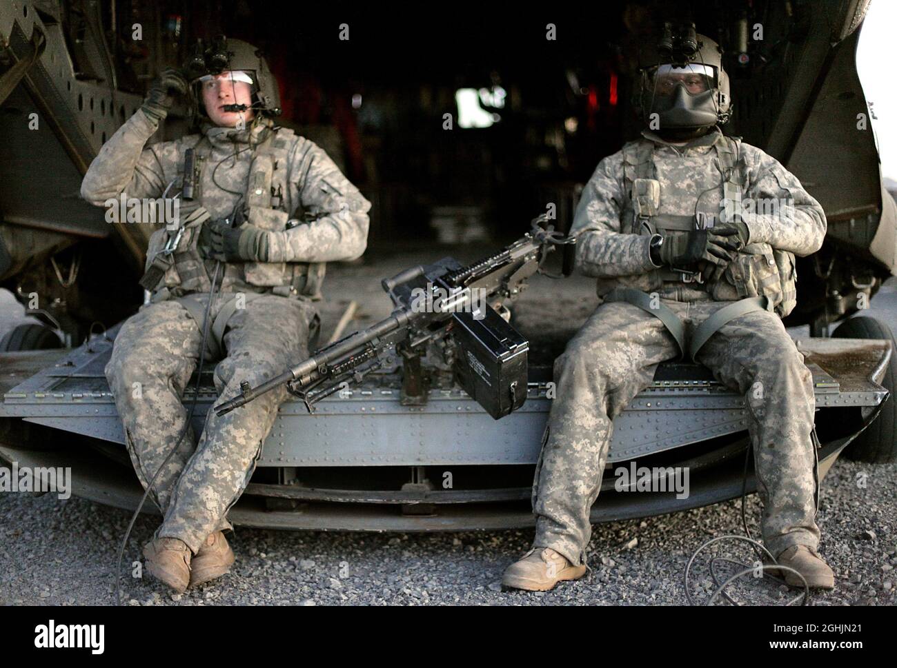 CH-47 Chinook helicopter crew chiefs rest on the ramp during a refuel ...