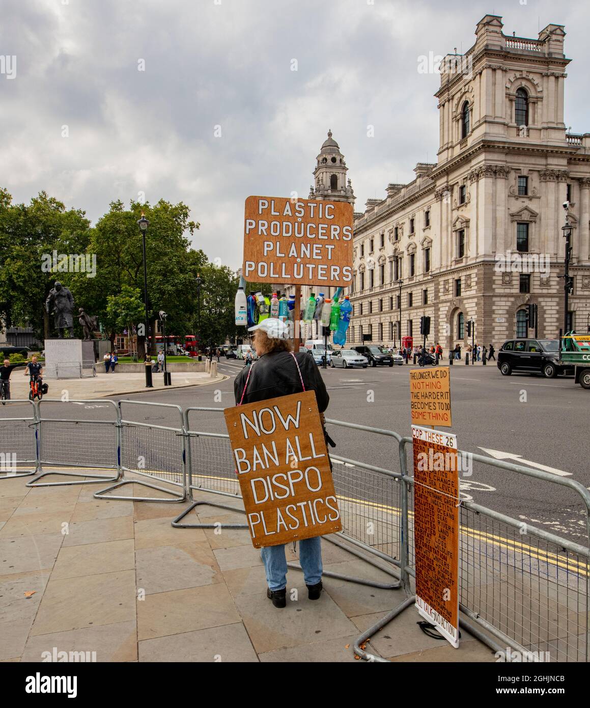 Man standing in Parliament Square with placards decrying use of plastic ...