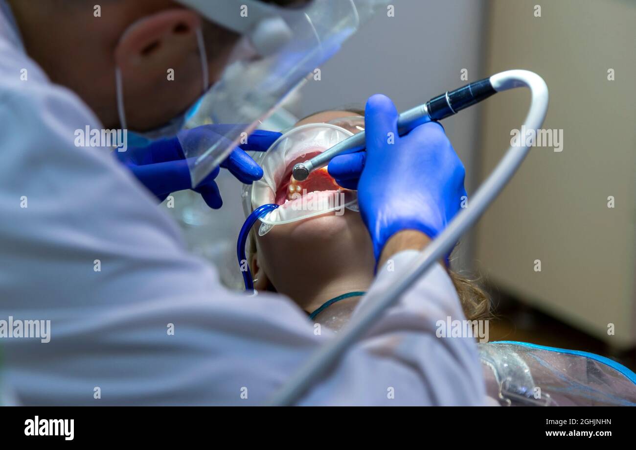 A dentist with dental instruments, a professional doctor drills his ...