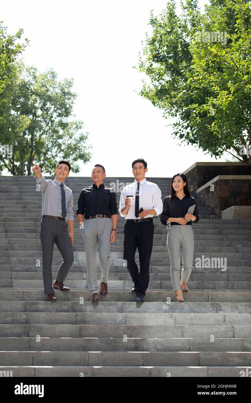Business people walking outdoors Stock Photo - Alamy