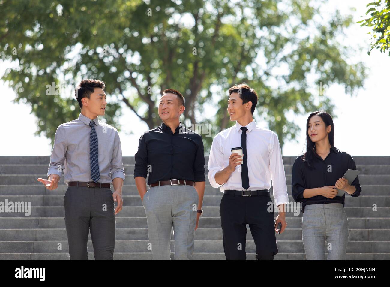 Business people walking outdoors Stock Photo - Alamy