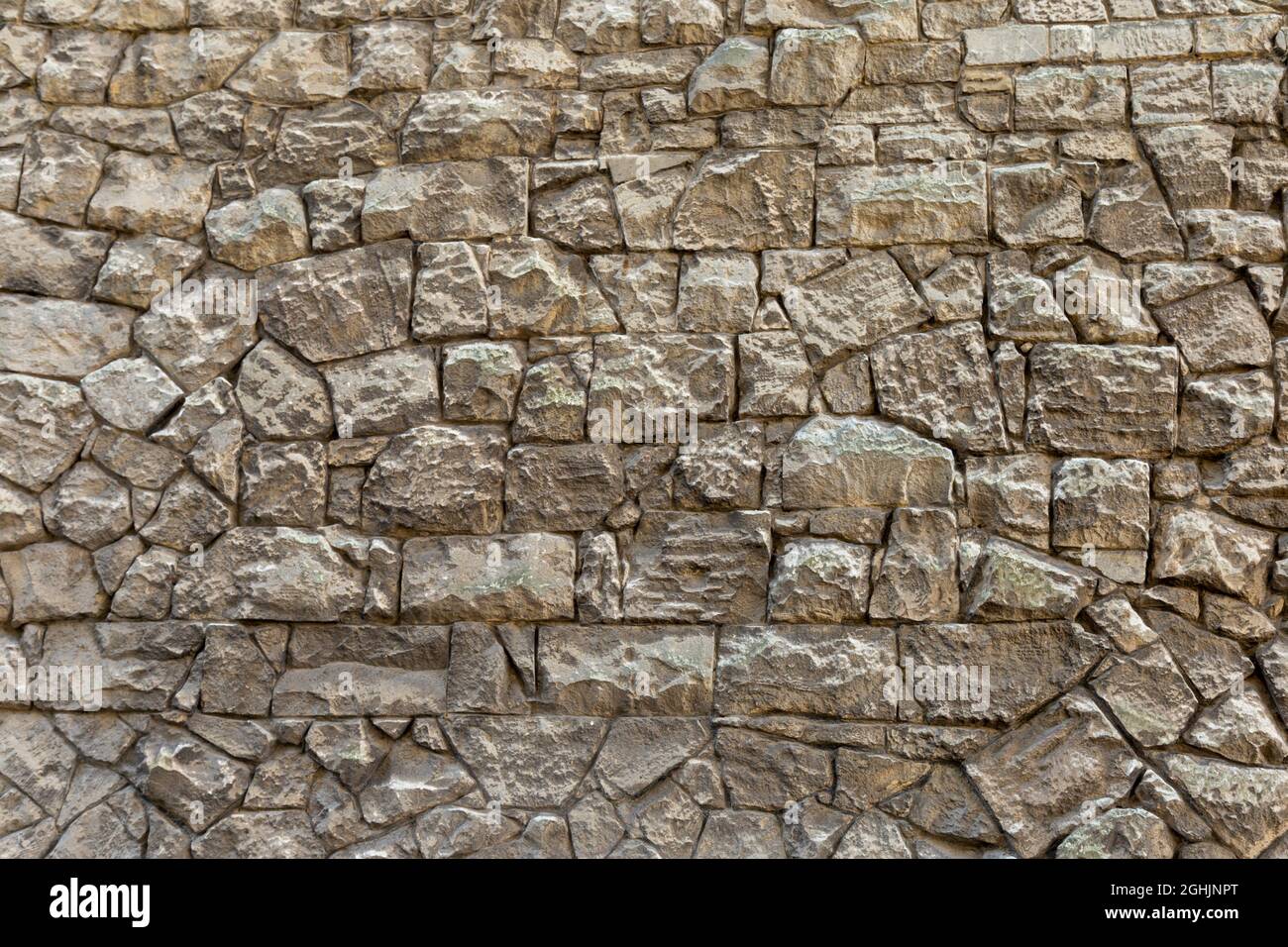 The texture of an old stone wall lined with small stone Stock Photo - Alamy