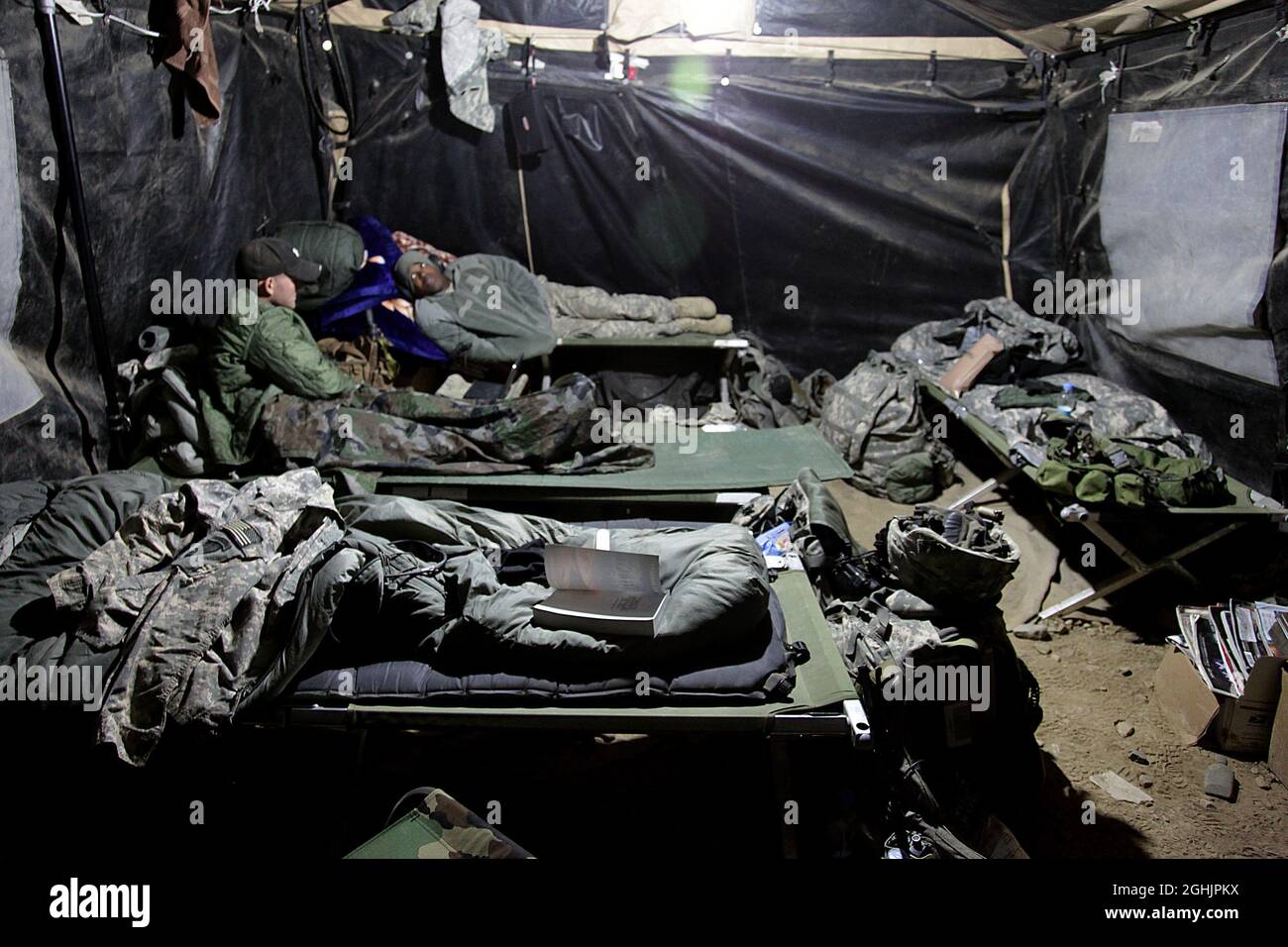 U.S. Army Soldiers watch a movie on a portable DVD player inside of ...