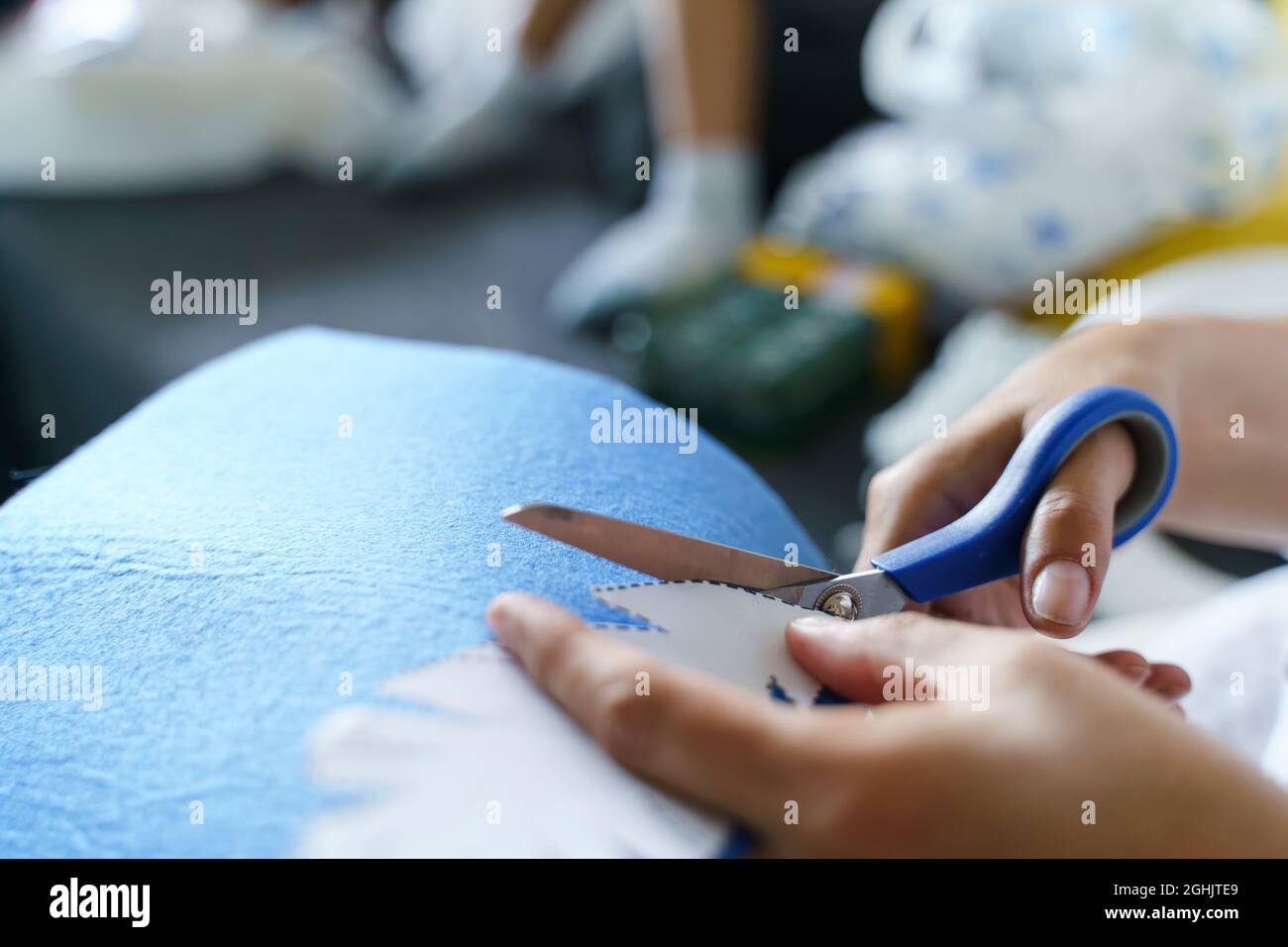 Close up on hands of unknown caucasian woman using scissors at home ...