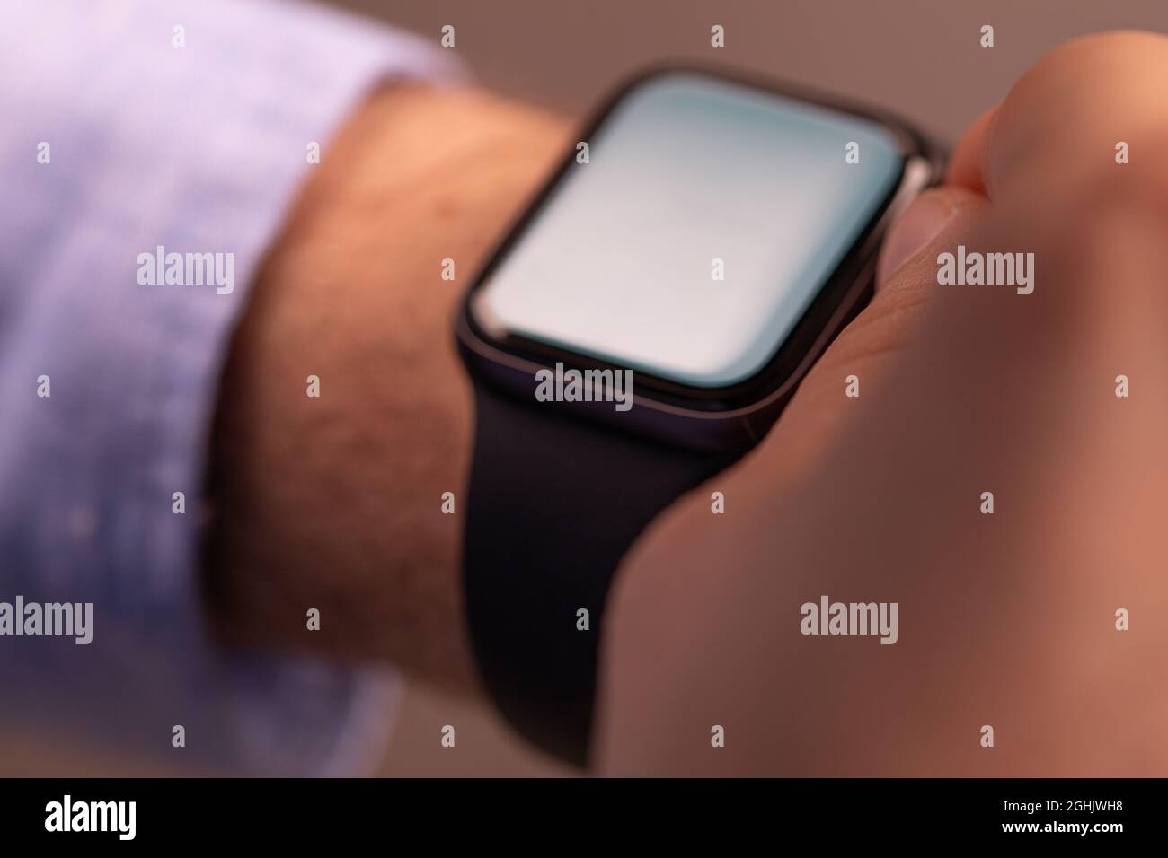 Closeup shot of a smartwatch on a person's wrist with a blank screen ...