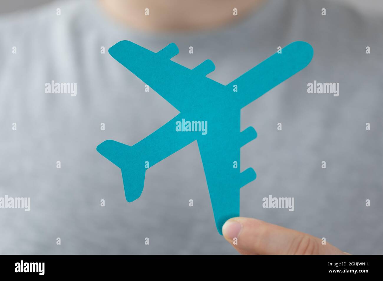 Hand holding an airplane icon Stock Photo - Alamy