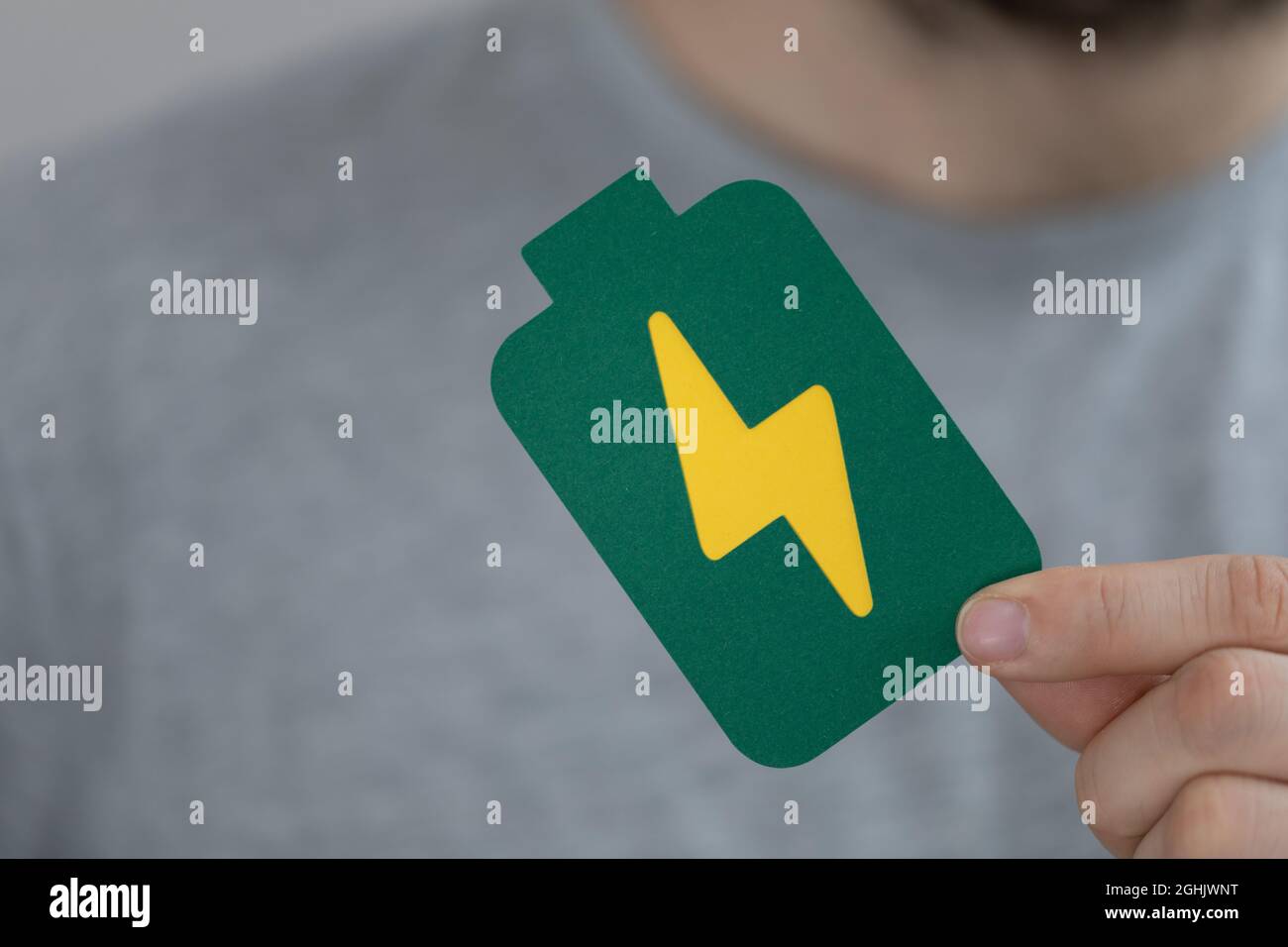 Hand holding a green and yellow sharing sign Stock Photo - Alamy