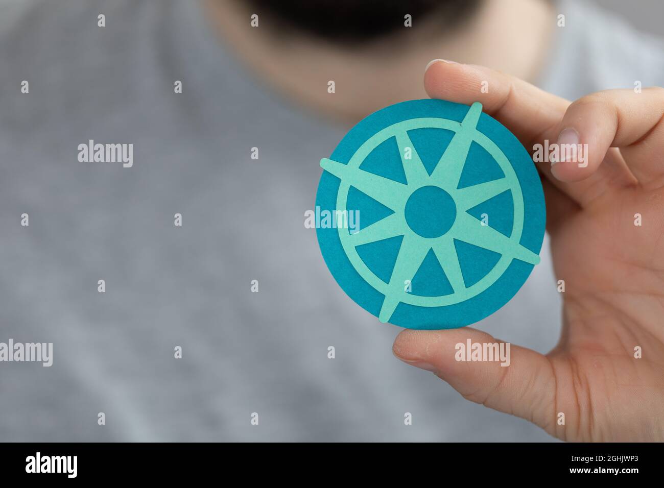 Hand holding a compass sign Stock Photo - Alamy