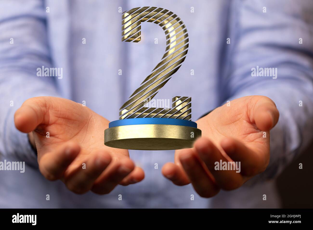 Holding a second-place gold trophy Stock Photo - Alamy