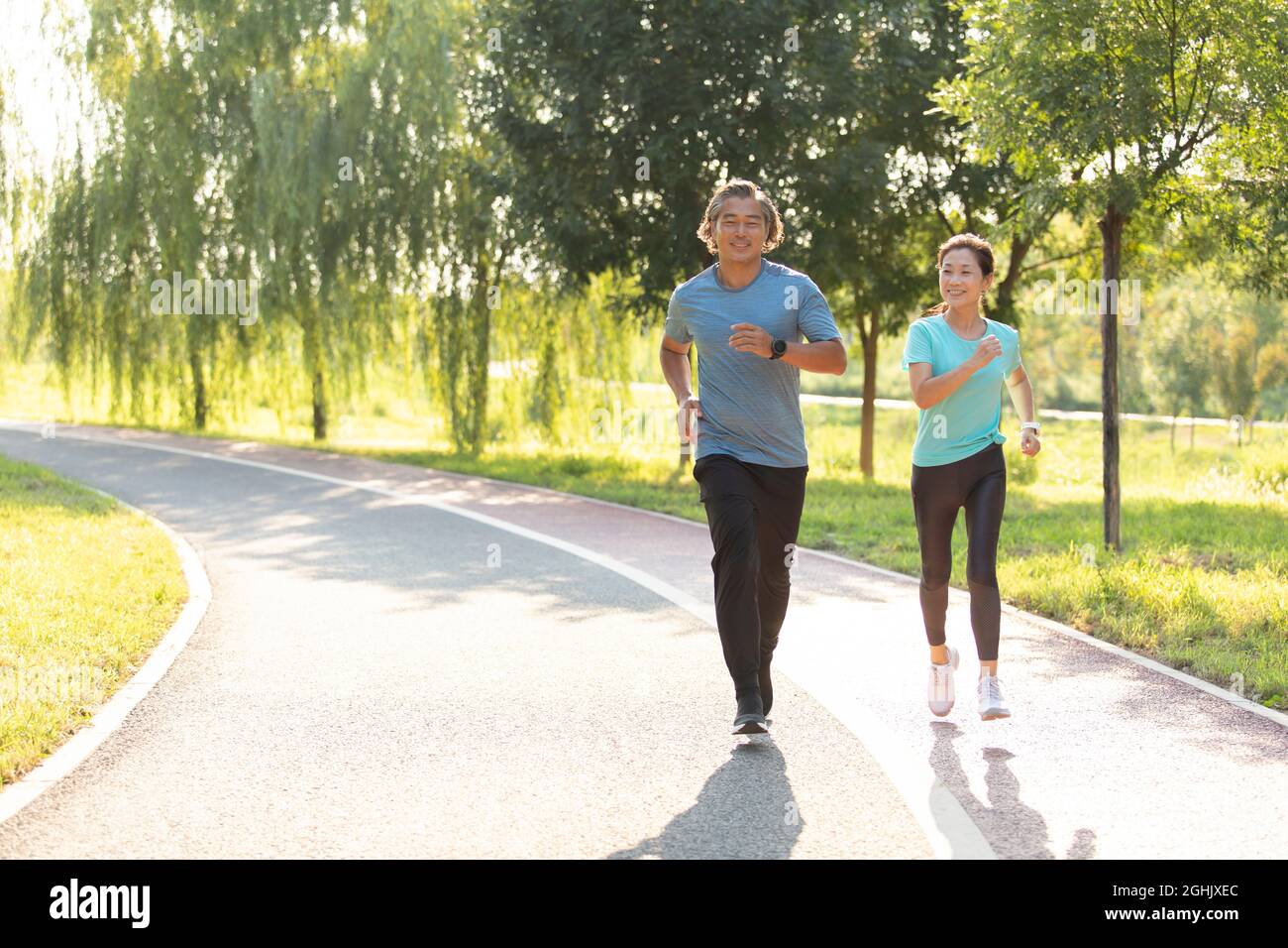 Couple in park looking at watch hi-res stock photography and images - Alamy
