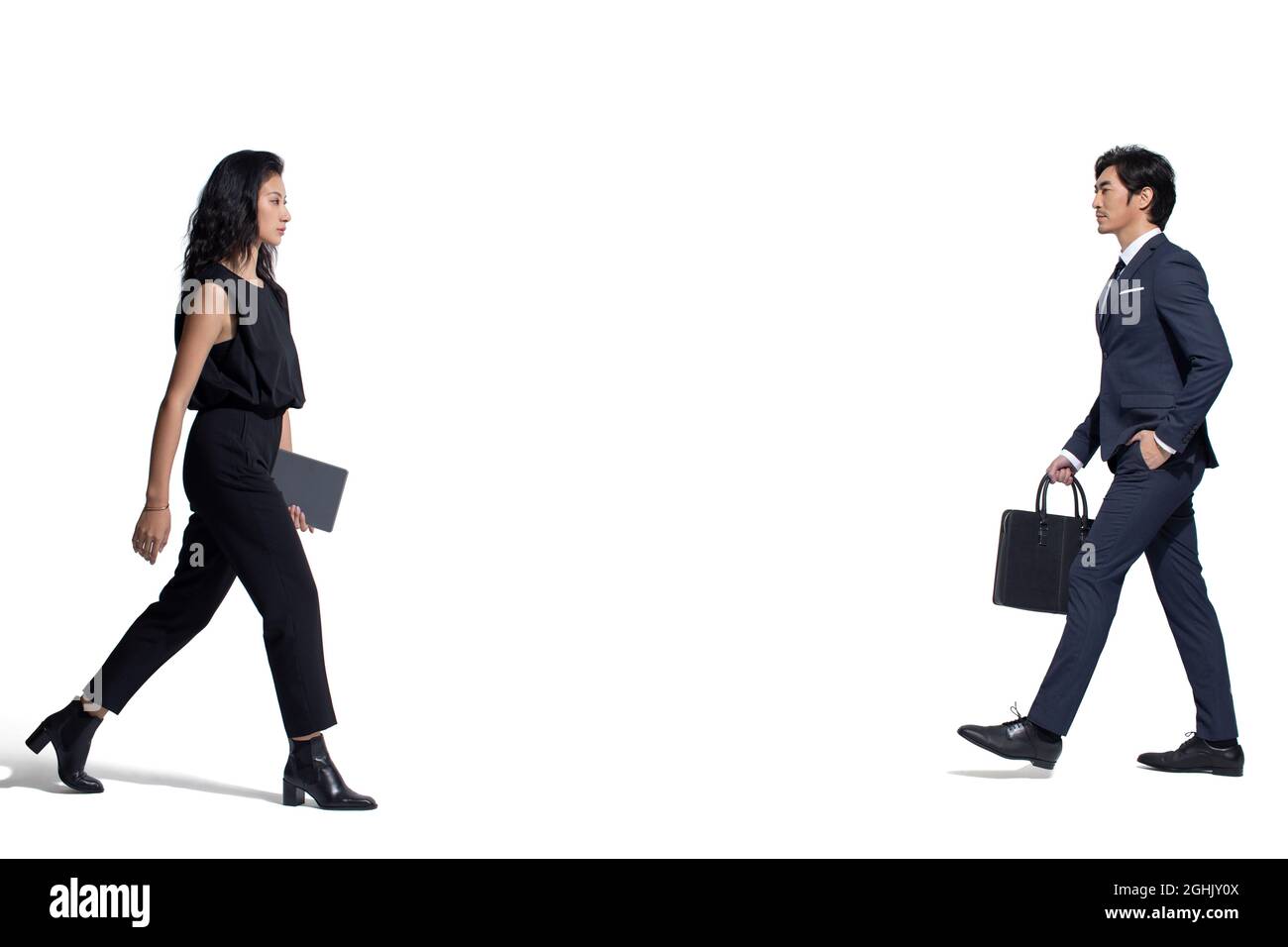 Two people walking side by side Cut Out Stock Images & Pictures - Alamy