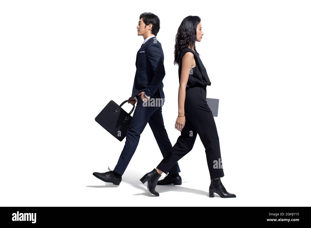Two people walking side by side Cut Out Stock Images & Pictures - Alamy
