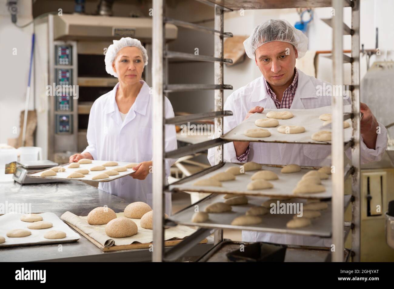 Experienced baker carrying formed products Stock Photo - Alamy