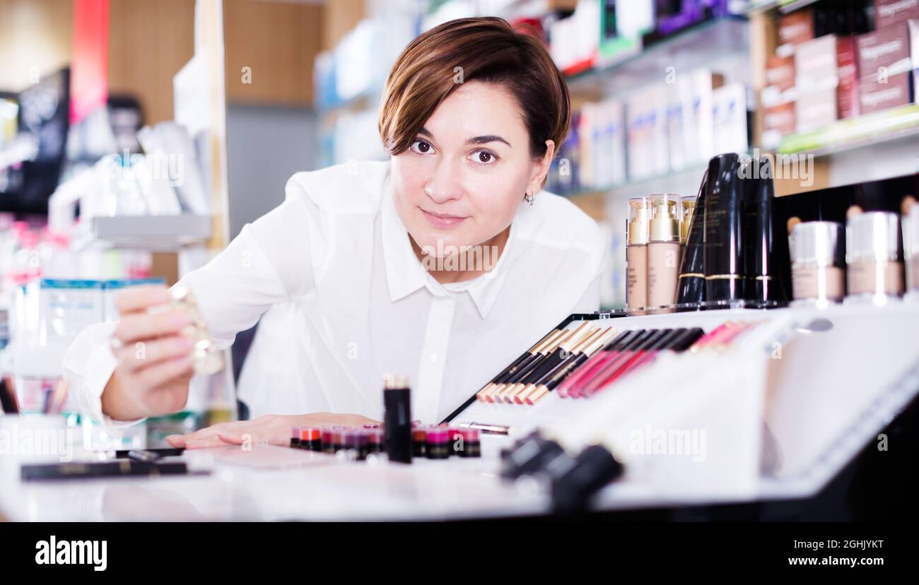 Customer browsing rows of cosmetic products Stock Photo - Alamy