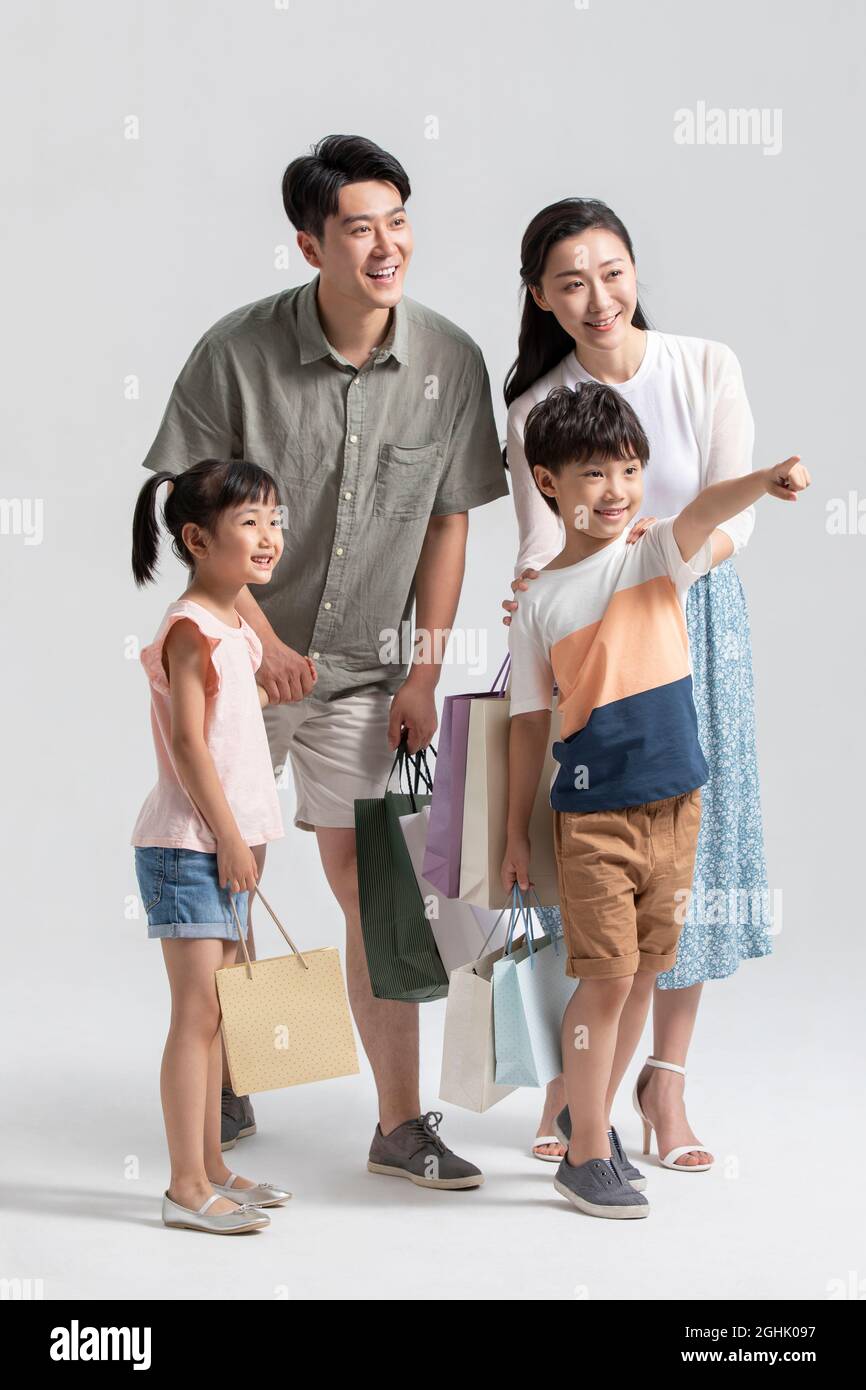 Happy young family shopping together Stock Photo - Alamy