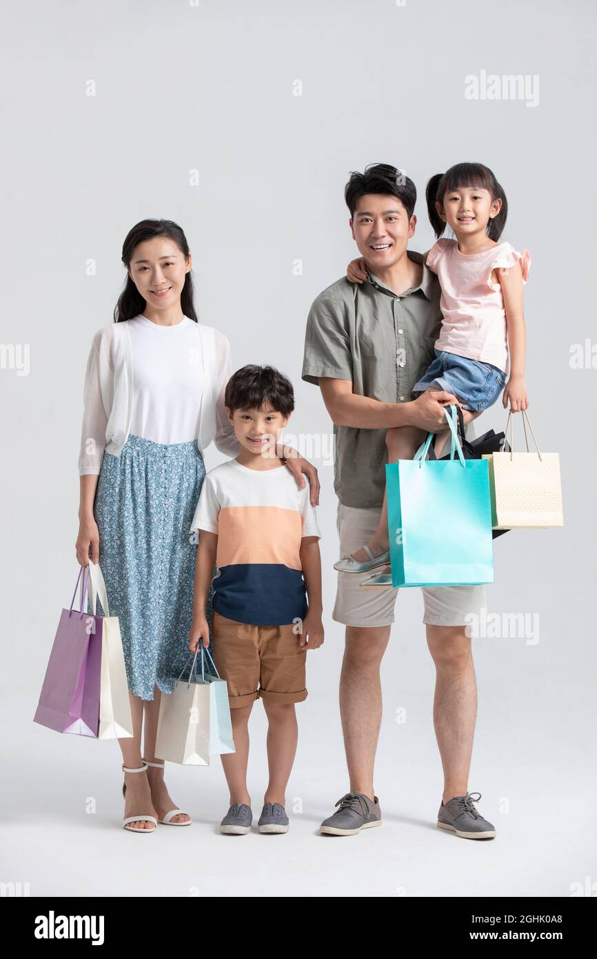Happy young family shopping together Stock Photo - Alamy
