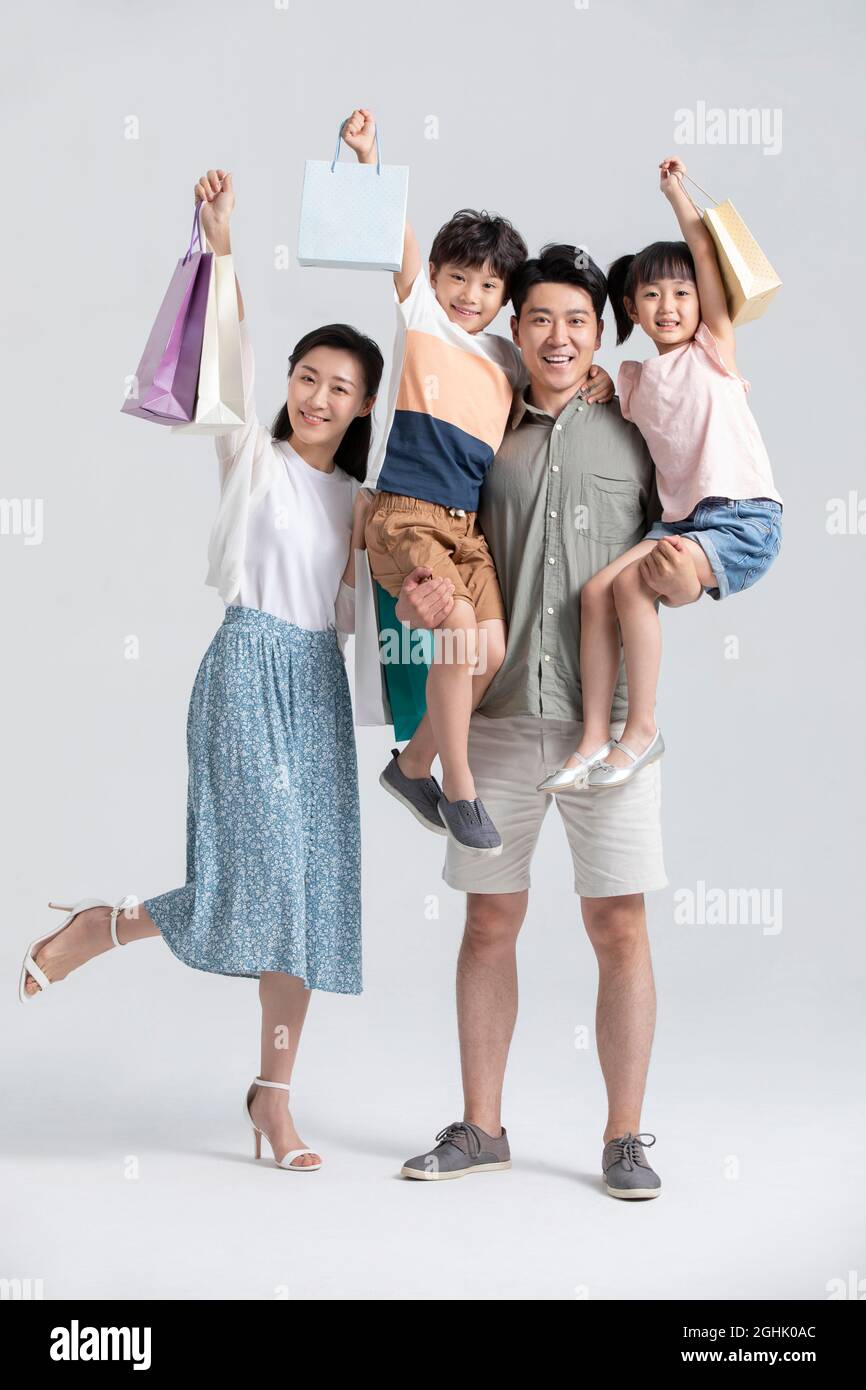 Happy young family shopping together Stock Photo - Alamy