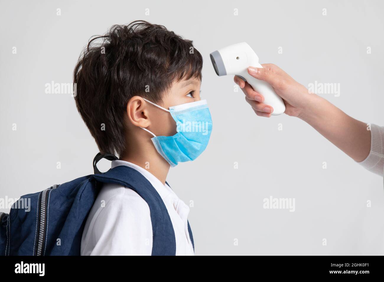 Measuring temperature with infrared thermometer before having the class ...