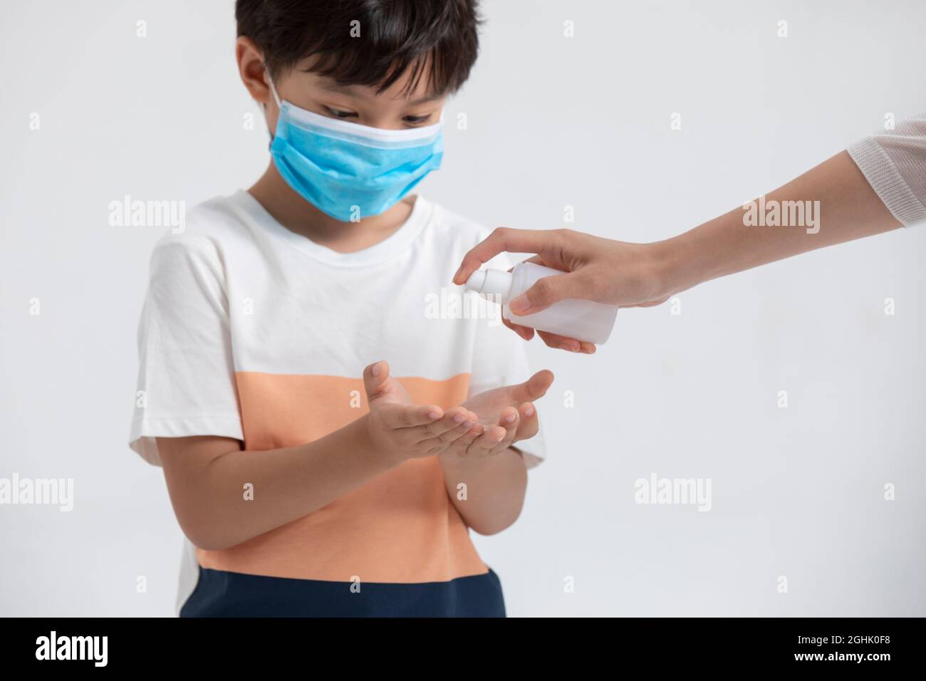 Little boy using hand sanitizer Stock Photo - Alamy