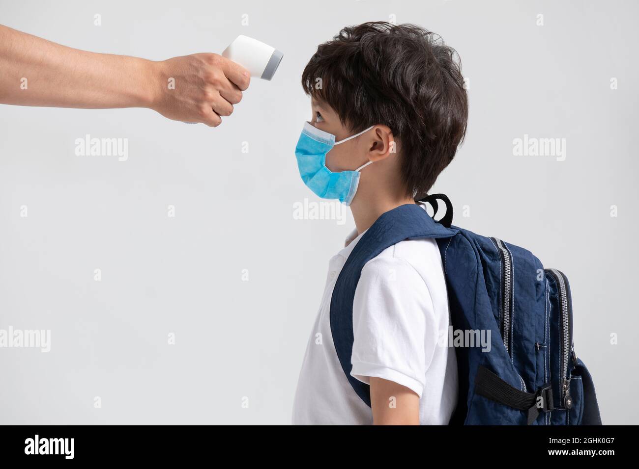 Measuring temperature with infrared thermometer before having the class ...