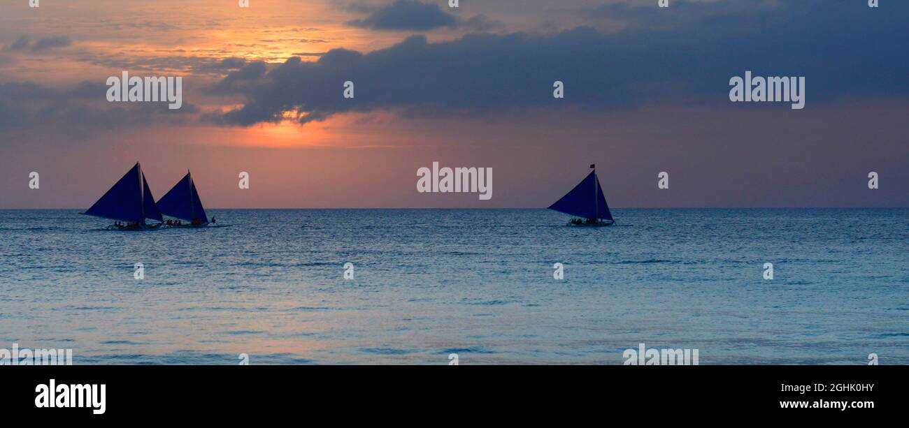 A romantic sunset enjoyed from the beach in Boracay island, Aklan ...