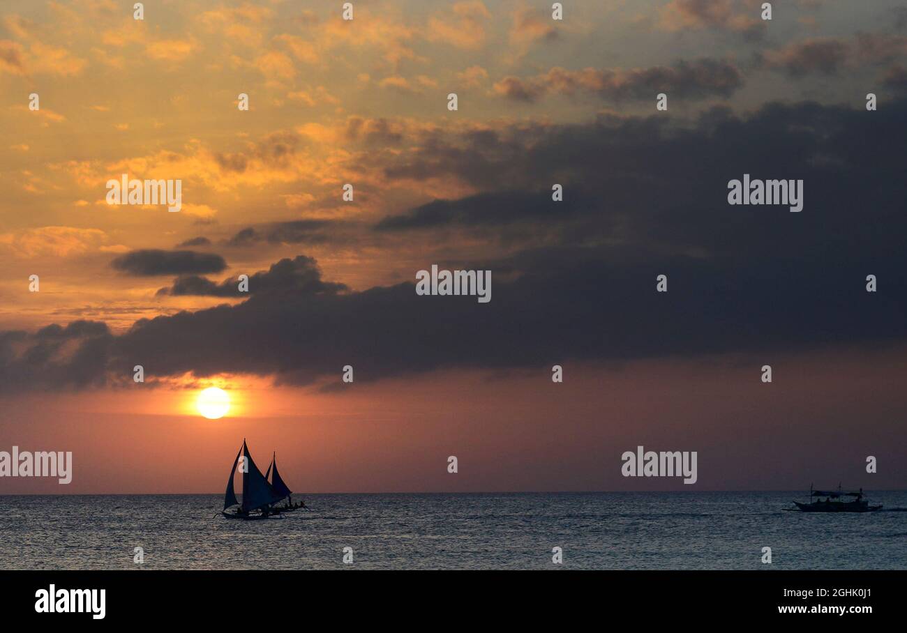 A romantic sunset enjoyed from the beach in Boracay island, Aklan ...