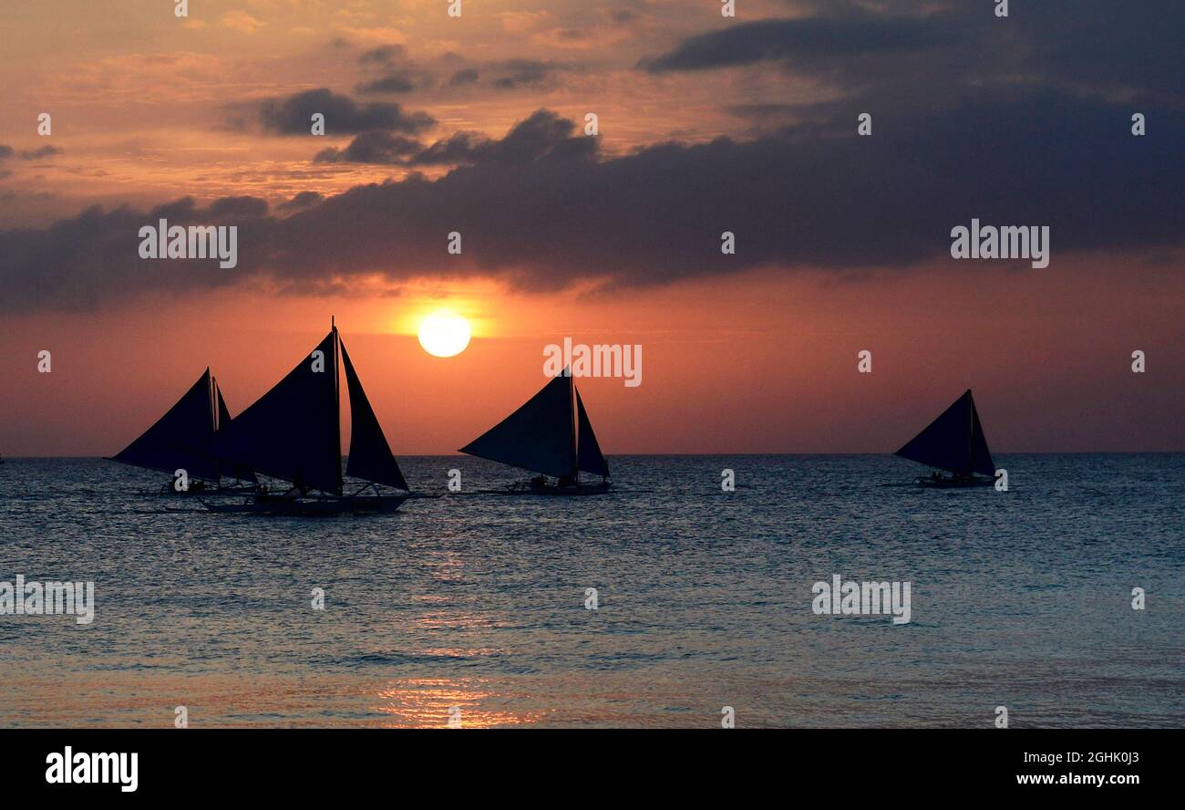 A romantic sunset enjoyed from the beach in Boracay island, Aklan ...